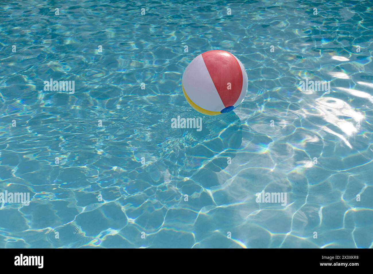 Colorful inflatable ball floating in the pool Stock Photo - Alamy