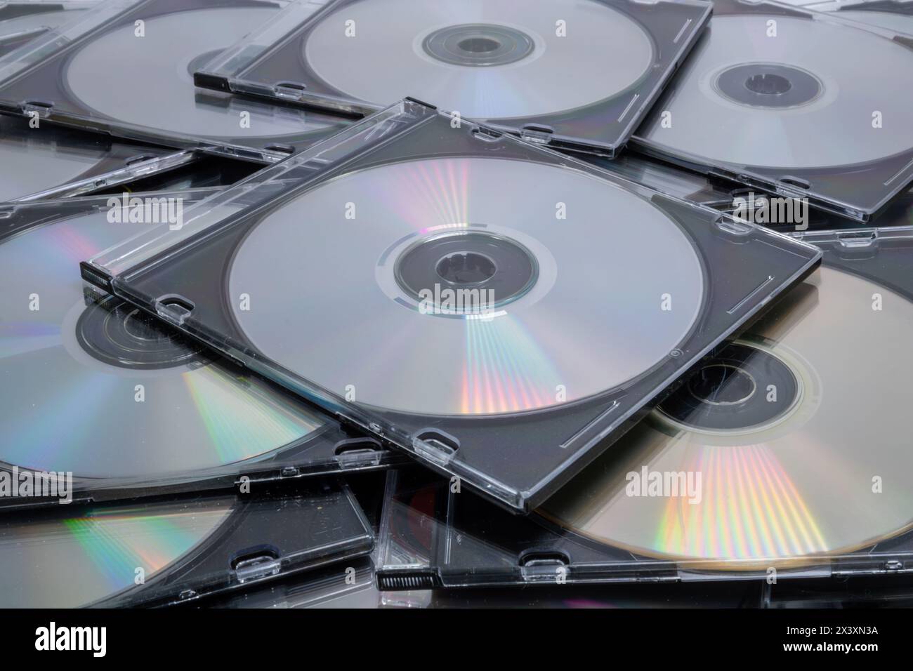 A pile of CD cases with CD discs on white background Stock Photo - Alamy