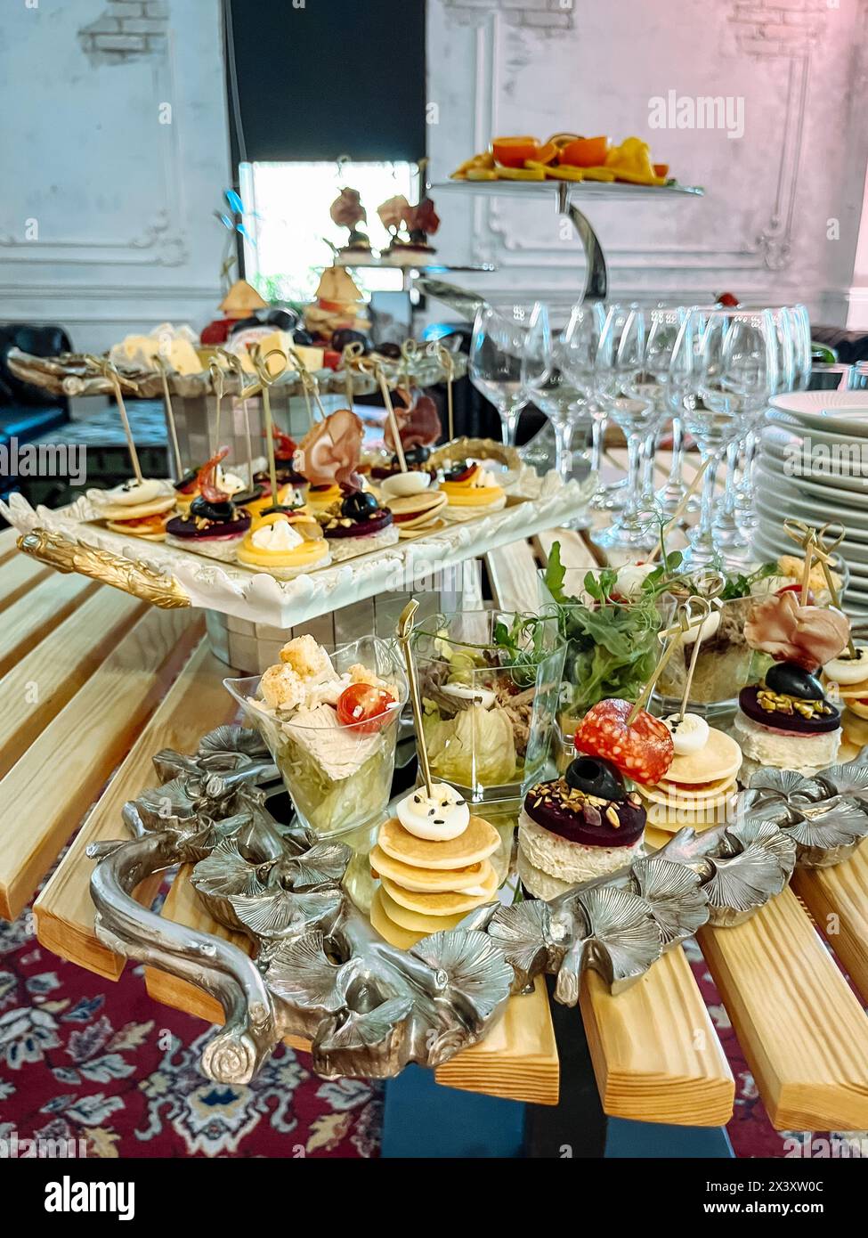 Catering buffet table with appetizers, desserts, canapes, quiches ...