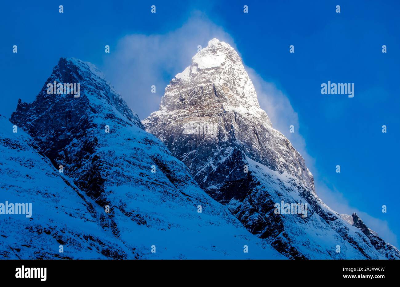 Norway, city of Tromso, sunrise on a mountain peak covered with snow ...