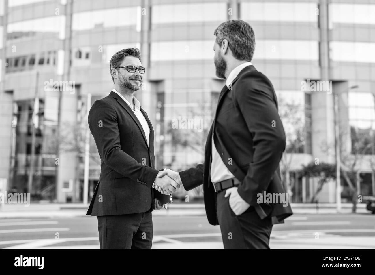 image of two businessmen deal with handshake. two businessmen deal with ...