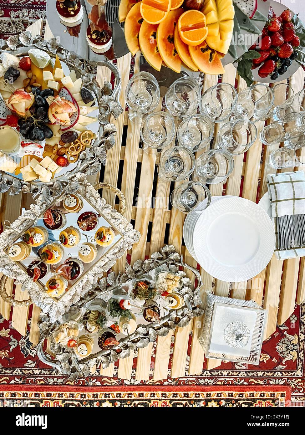 Catering buffet with sweet and savory appetizers, fruit platter with ...