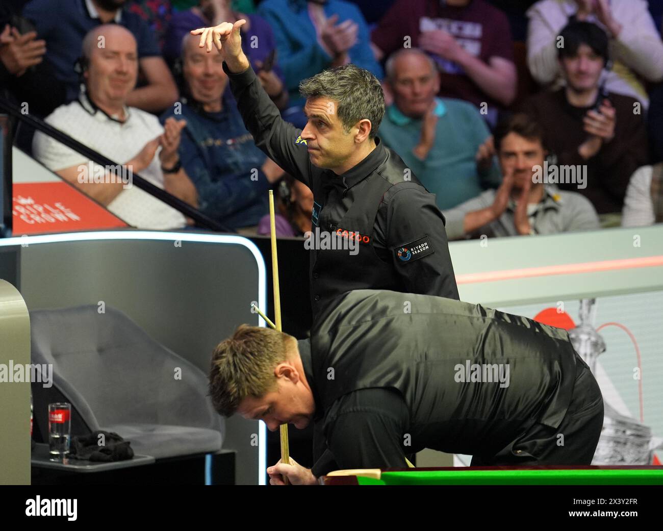 Ronnie O'Sullivan (left) bumps into Ryan Day after their match on day ...