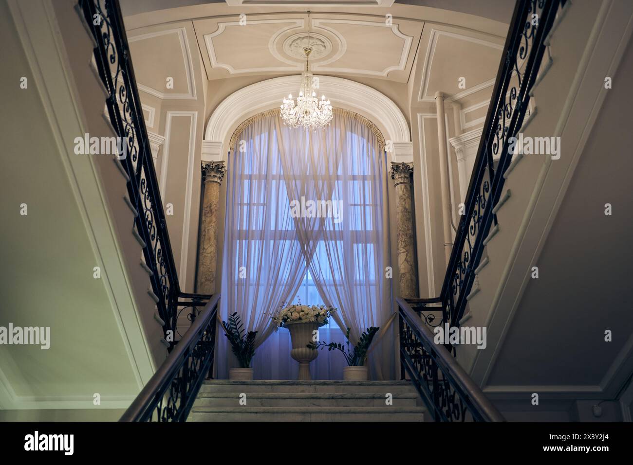 A large window with a staircase in a Baroque and classicist palace ...