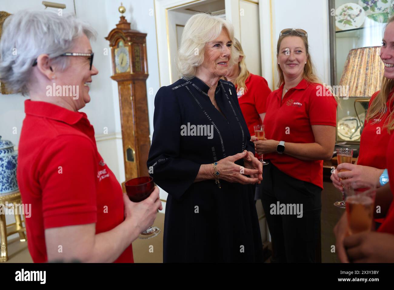 Queen Camilla, speaks to crew members as she hosts a reception for the ...