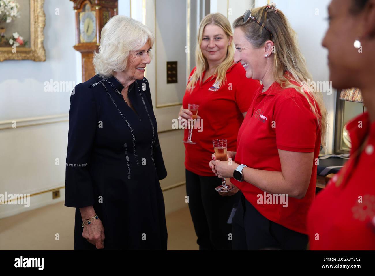 Queen Camilla, speaks to crew members as she hosts a reception for the ...
