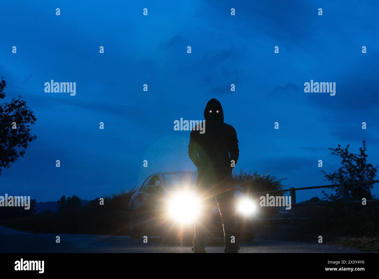 A horror concept of a supernatural demon like entity with glowing eyes ...