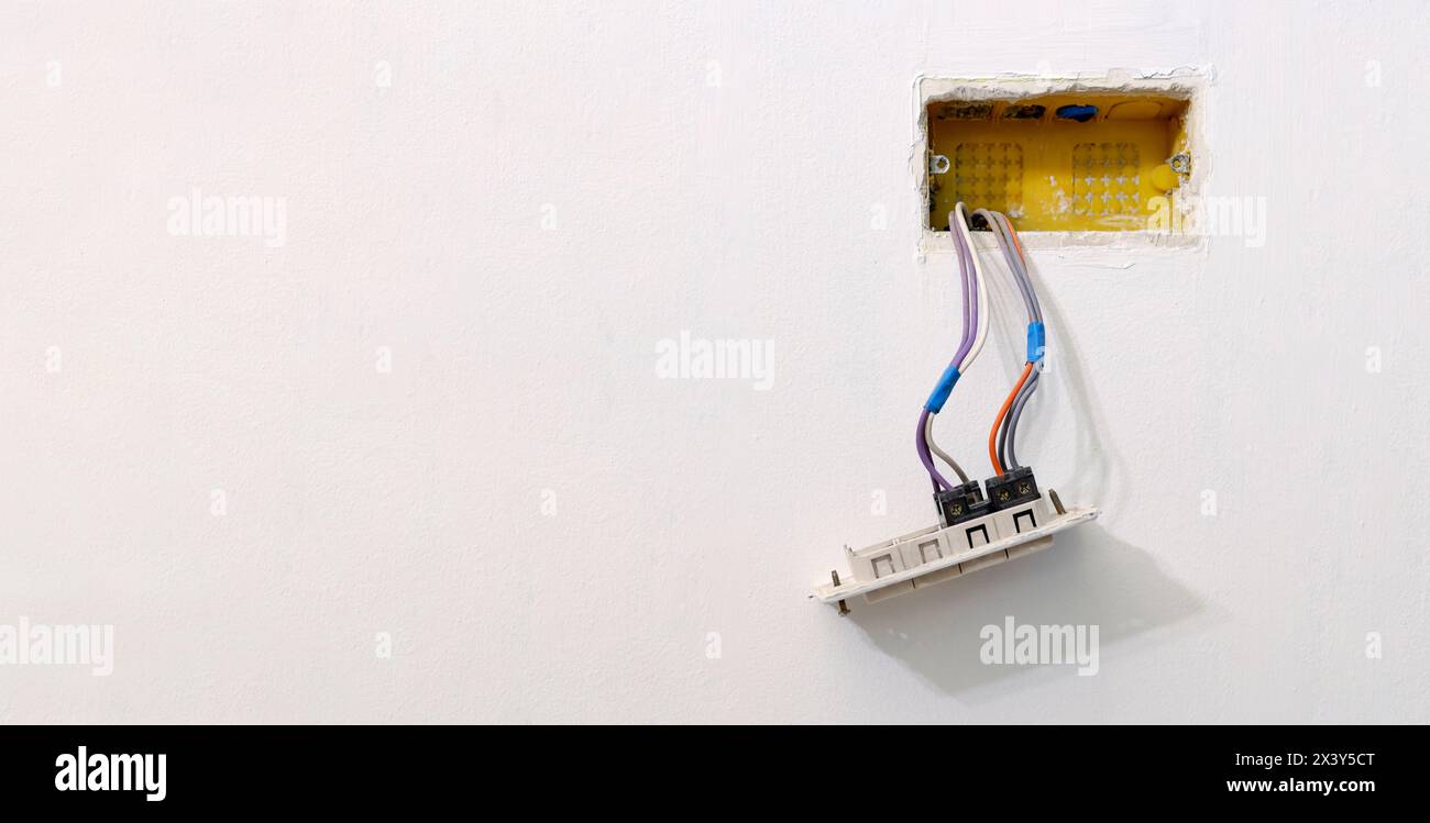 Colored electrical cables coming out of a corrugated tube of an ...
