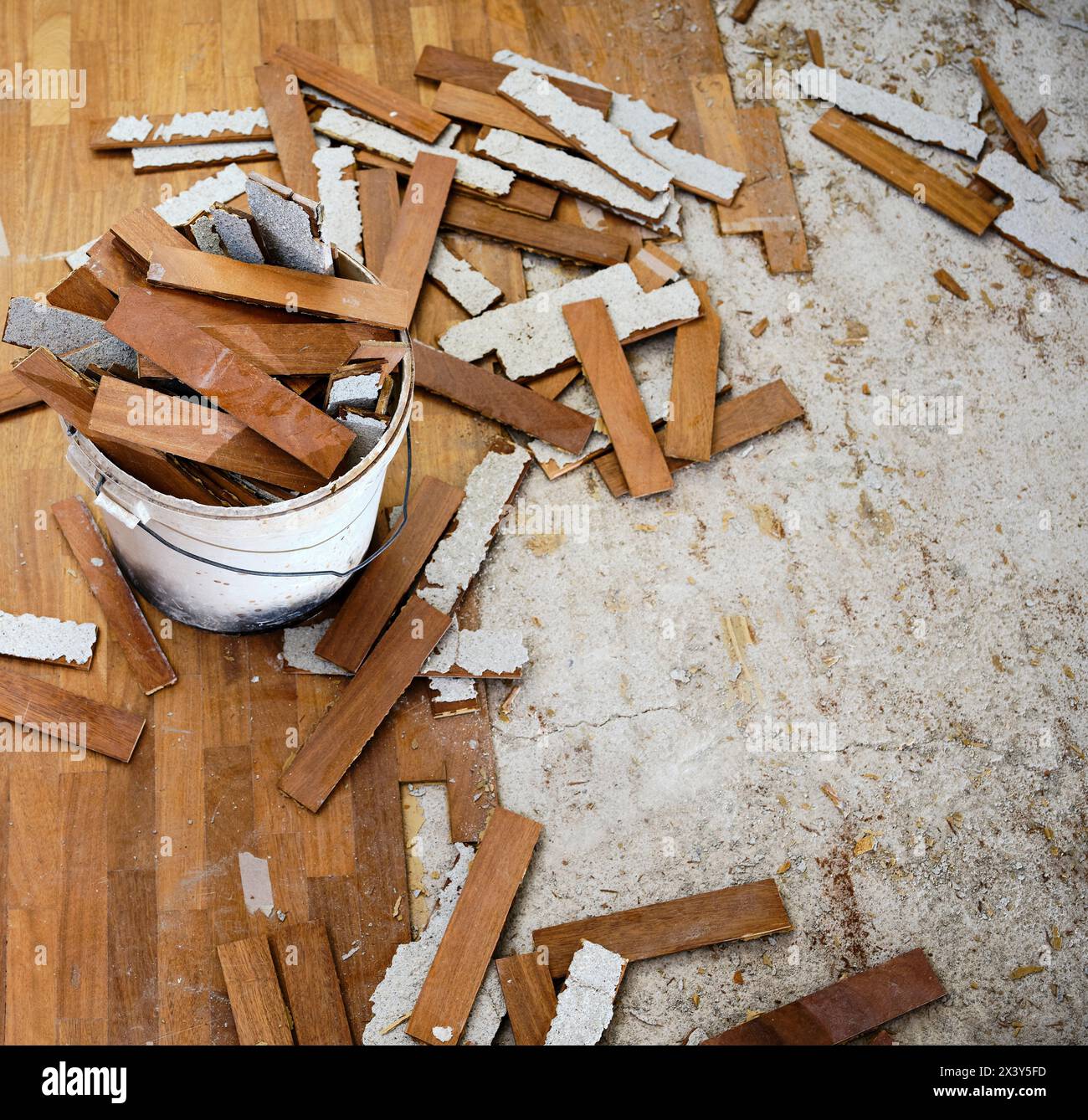 Craftsman in workwear removes the parquet flooring and fills the ...