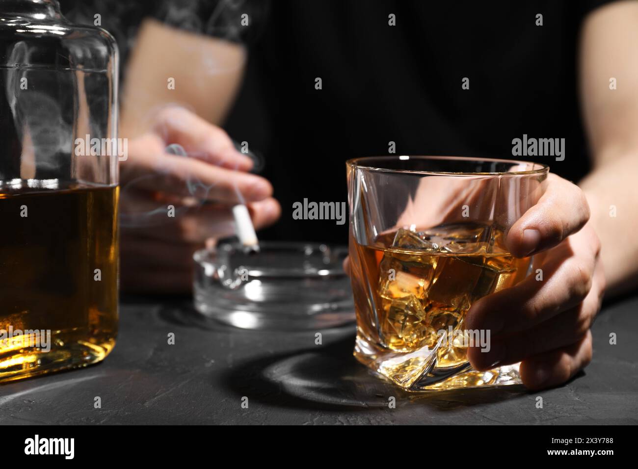 Alcohol addiction. Man with glass of whiskey and smoldering cigarette ...