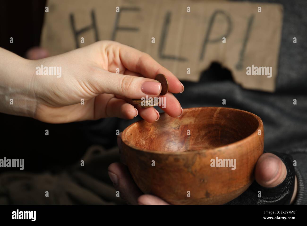 Woman giving coins to poor homeless man with bowl of donations and help ...