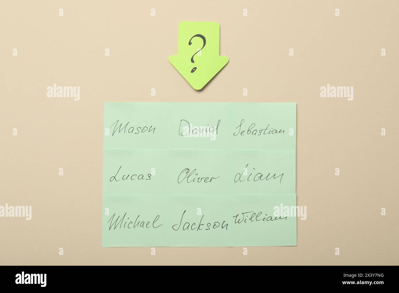 Choosing baby`s name. Paper stickers with different names and question ...