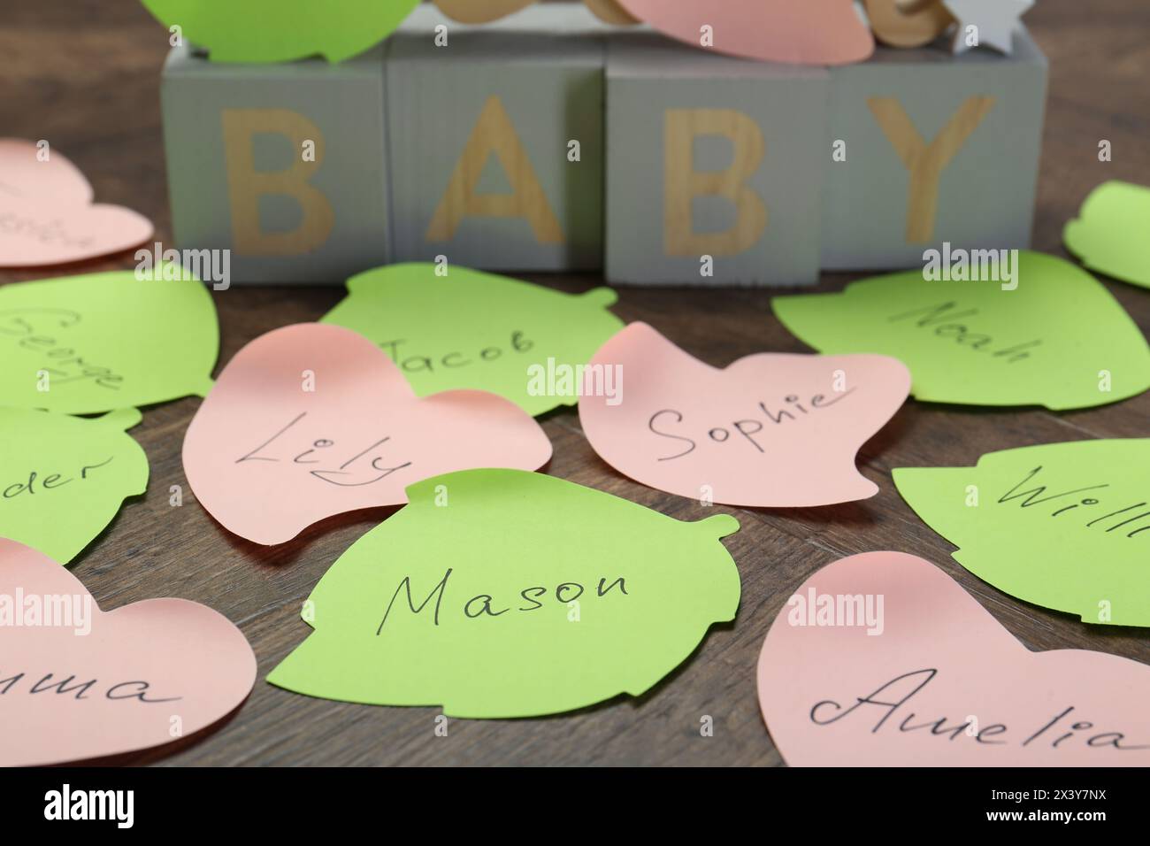 Cubes with word Baby and paper stickers with different names on wooden ...