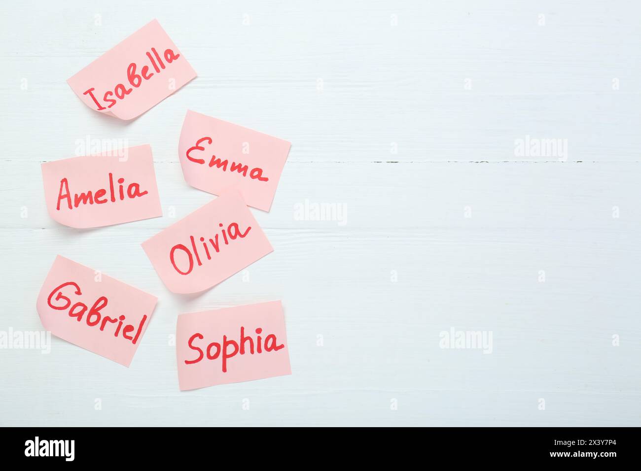 Choosing baby's name. Paper stickers with different names on white ...
