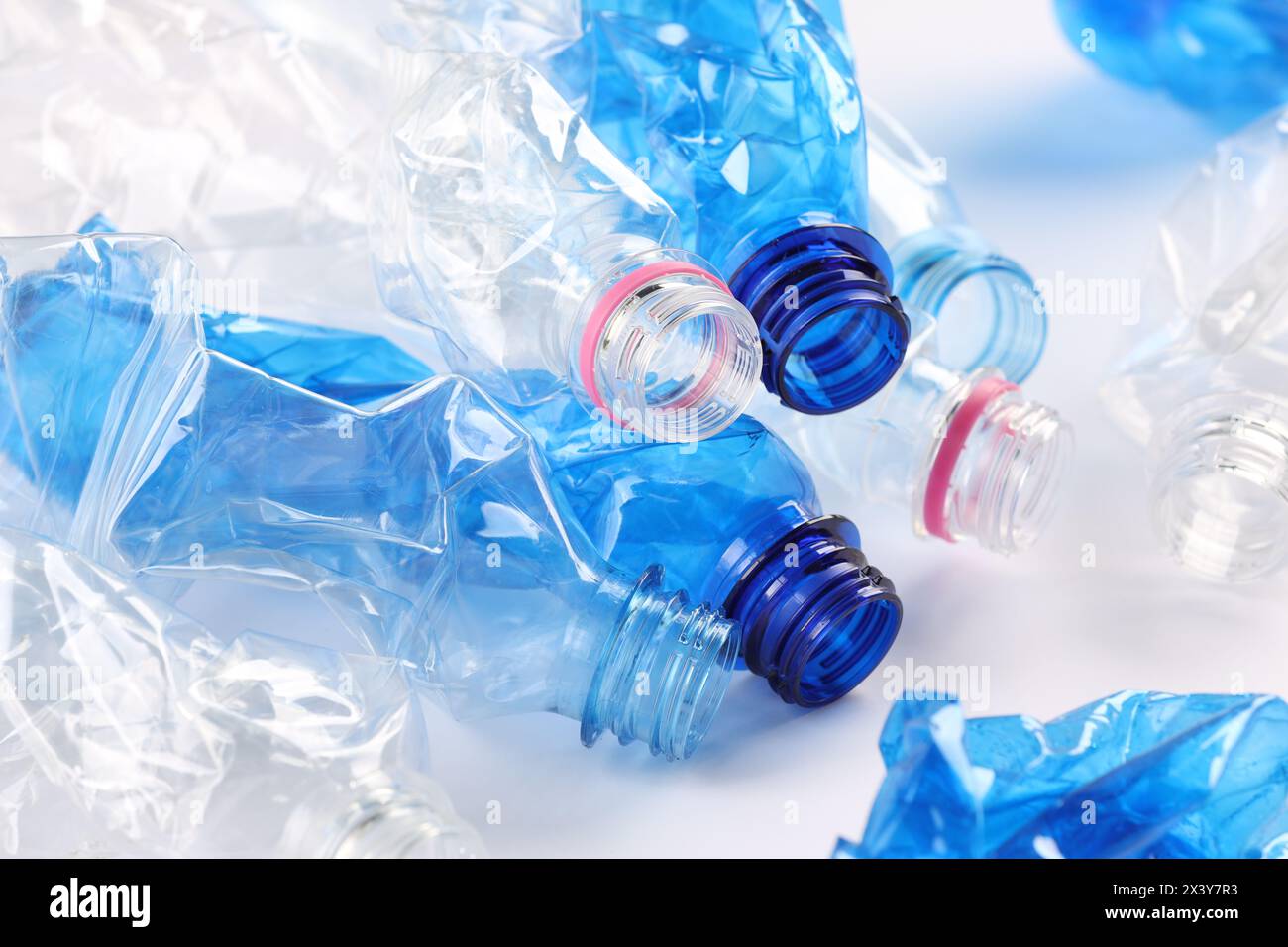 Crumpled disposable plastic bottles on white background Stock Photo - Alamy