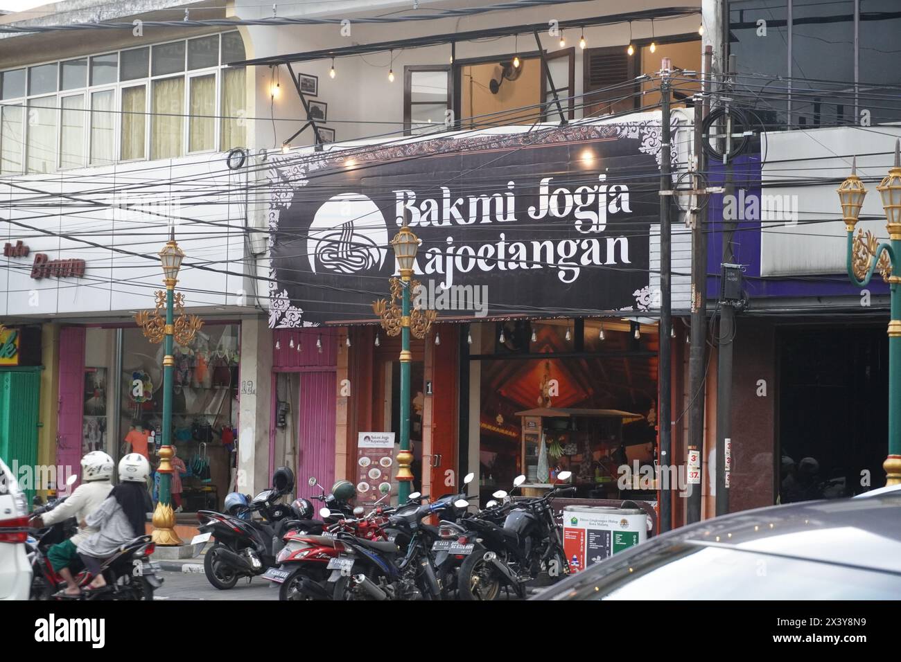 A "Bakmi Jogja" noodle restaurant located on the side of the road in ...