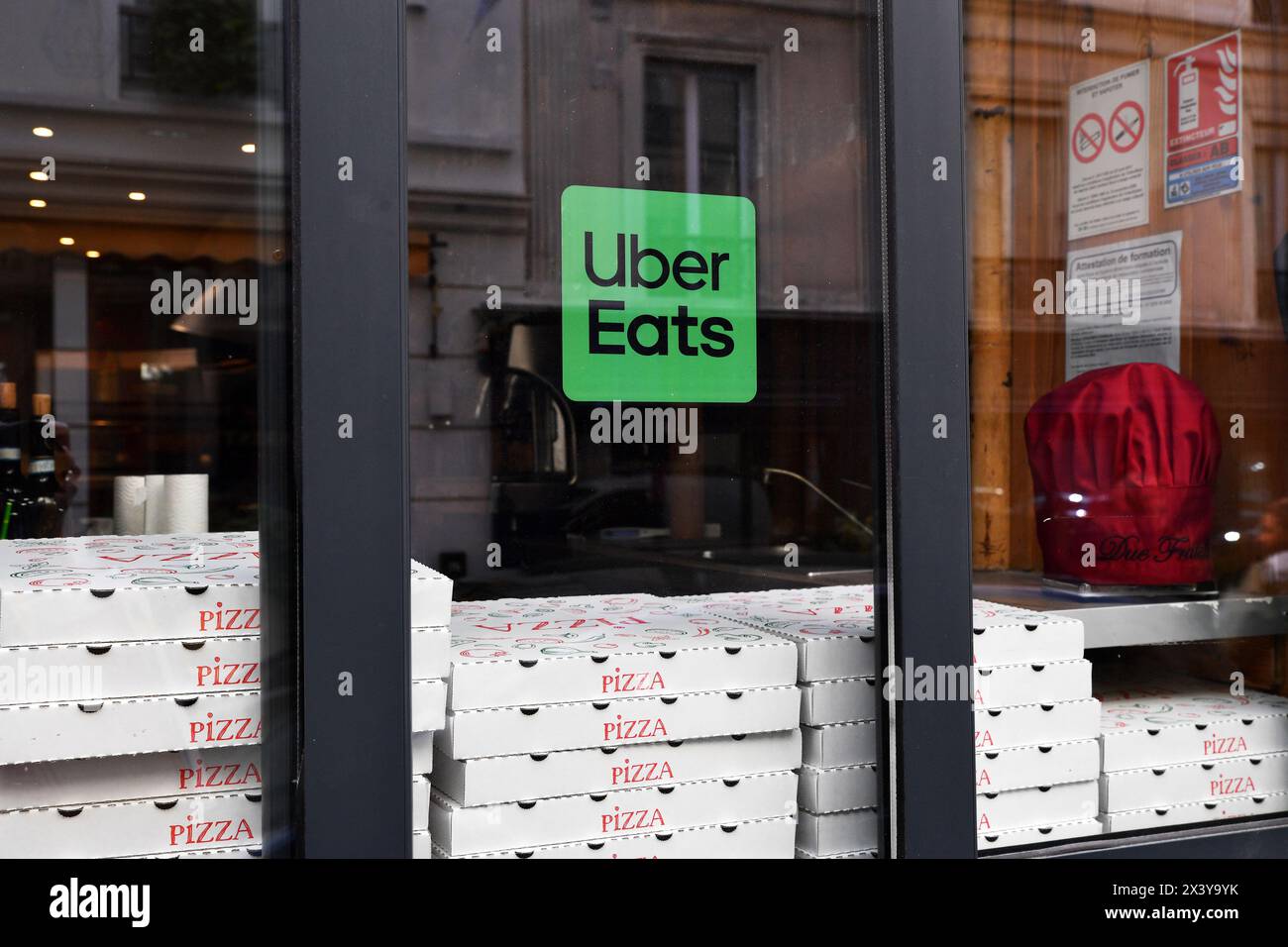 Uber Eats sign in a pizzeria on Clichy Boulevard - Paris - France Stock ...