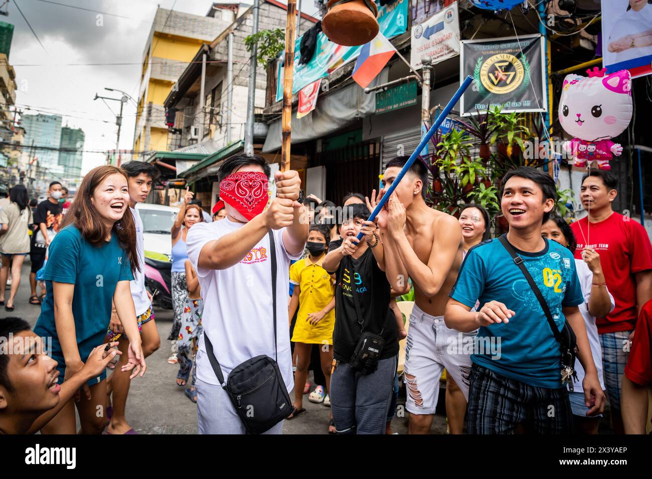 Filipino children play street games together during an annual religious ...