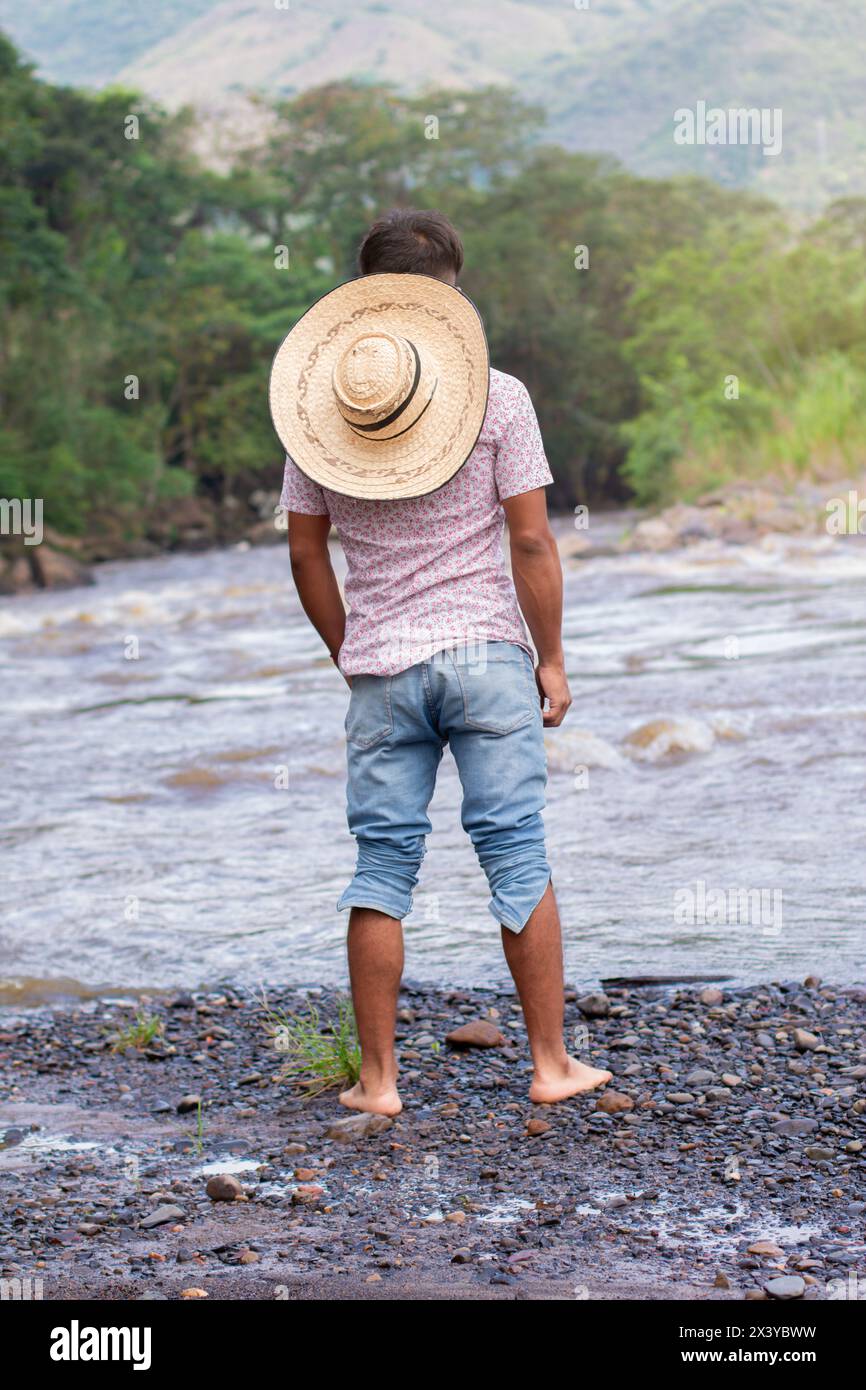 lifestyle, barefoot man standing on the river bank Stock Photo - Alamy