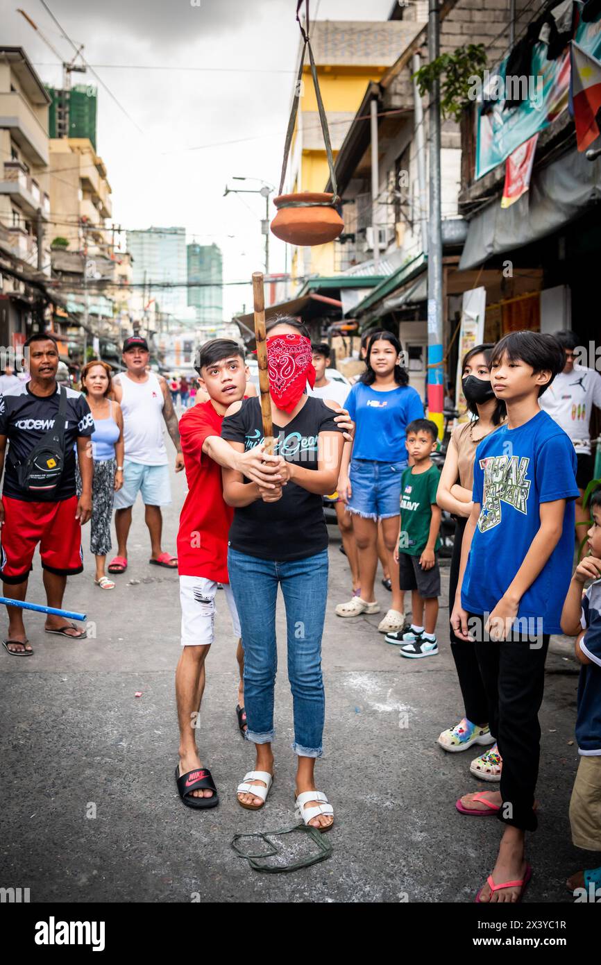 Filipino children play street games together during an annual religious ...