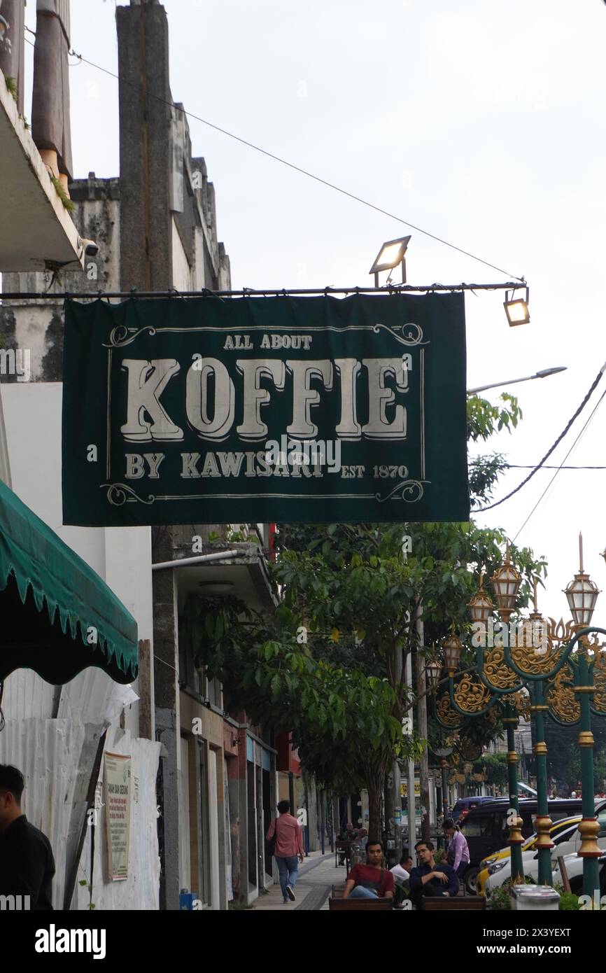 Coffee sign on the side of the road with vintage buildings Stock Photo ...