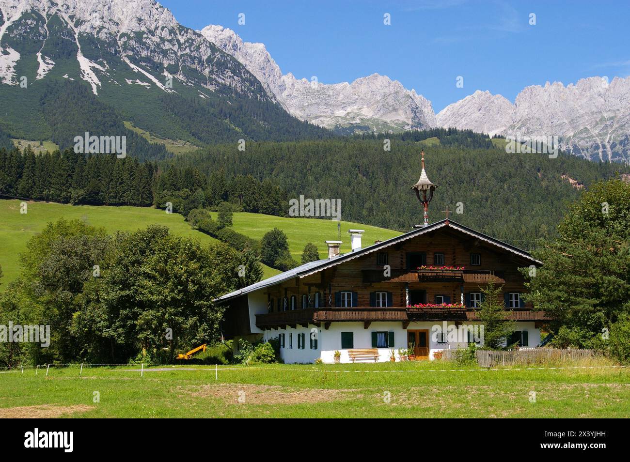 Traditional Tirolean Building with mountains behind Stock Photo - Alamy