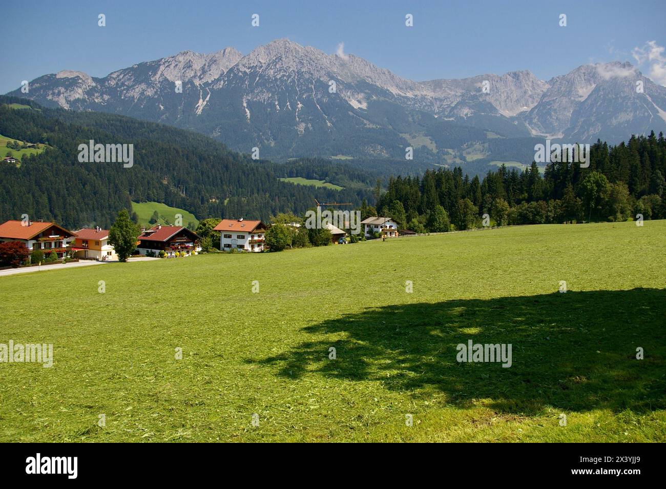 Traditional Tirolean Houses with mountains behind Stock Photo - Alamy