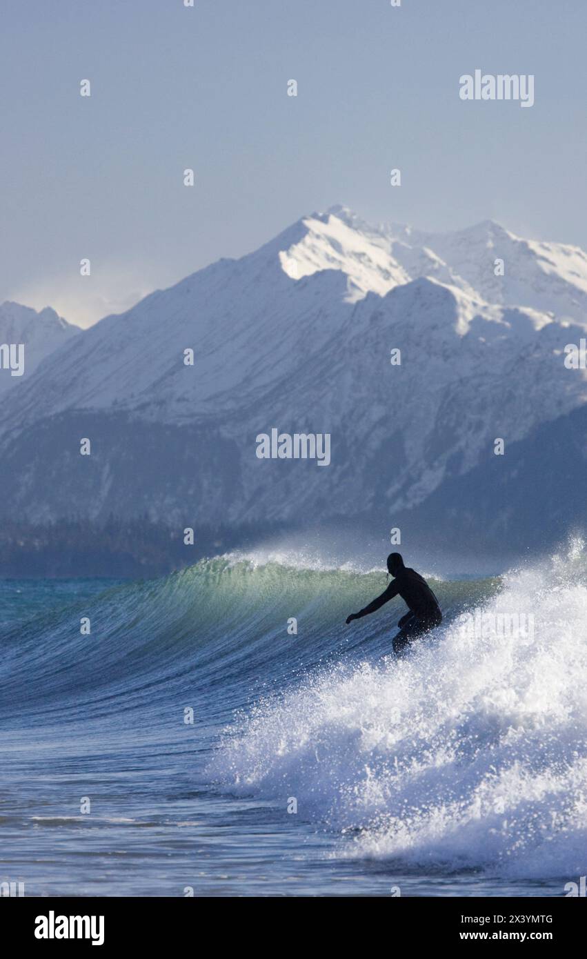 A surfer rides frigid waves in Homer, Alaska Stock Photo - Alamy