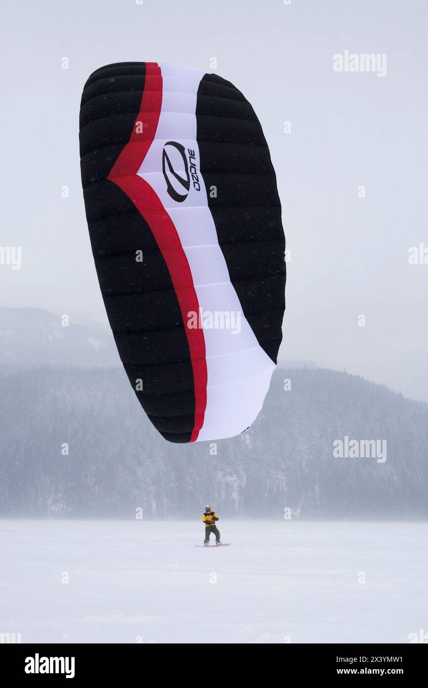 A mid adult man maneuvers a foil kite while snow kiting in Alaska Stock ...