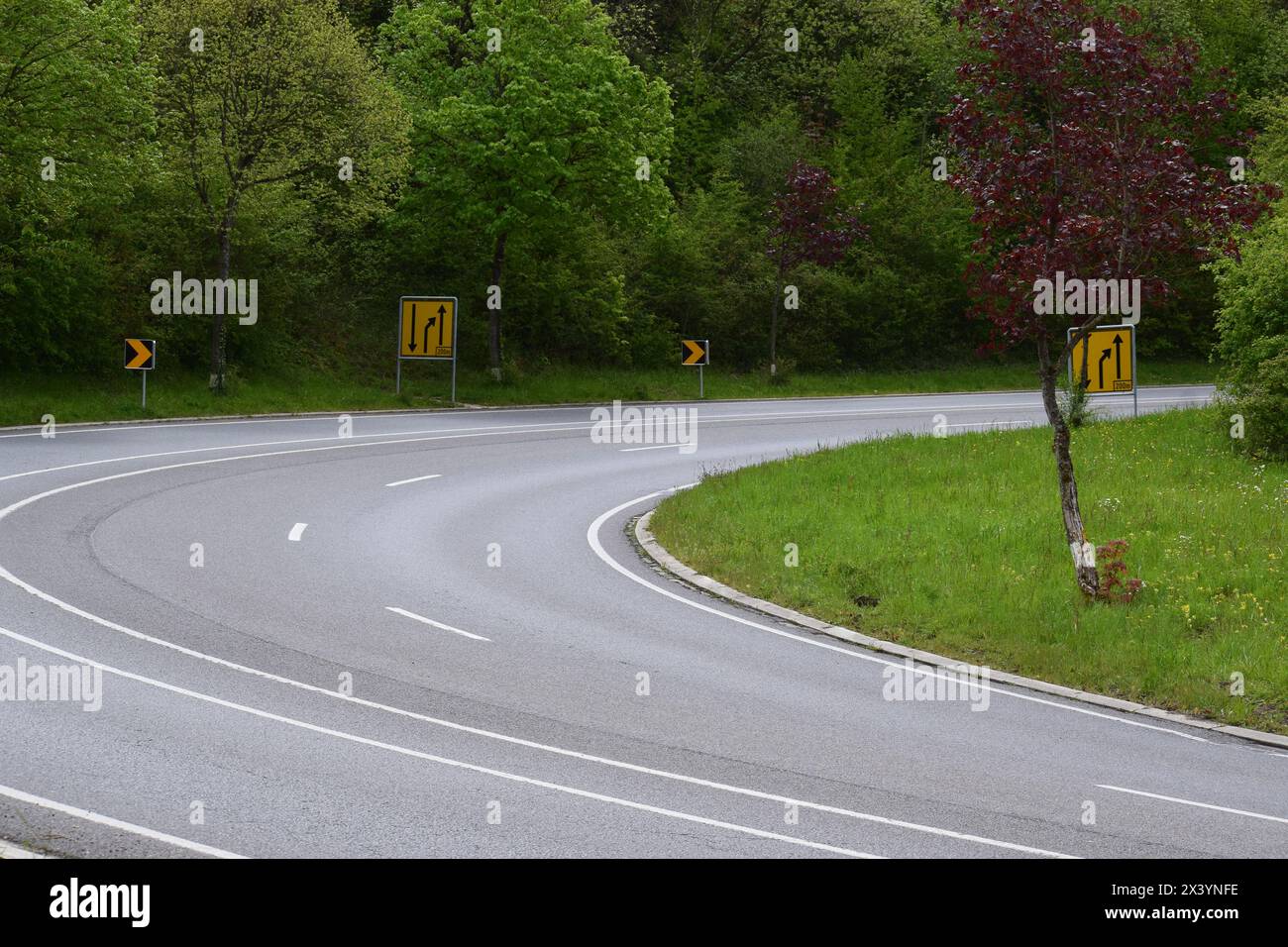 country road curve with red and green trees Stock Photo - Alamy