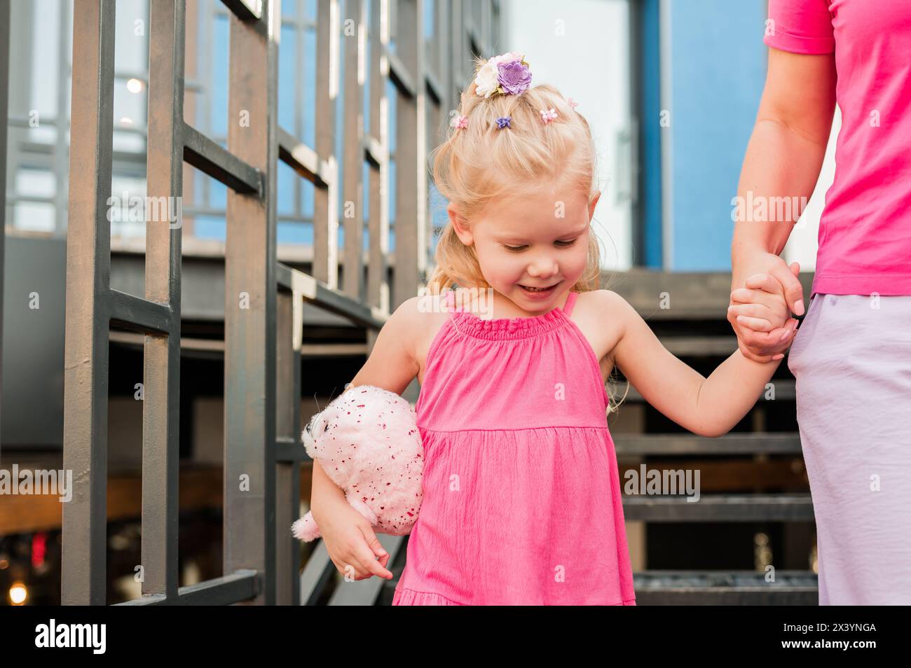 Child girl walks and have fun outdoor with cochlear implant on the head ...
