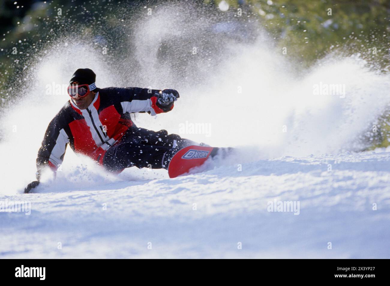 Snowboarder carving turns downhill Stock Photo - Alamy