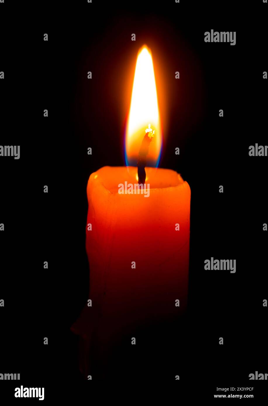 Warm color candle flame on black background. symbol of spirit ...