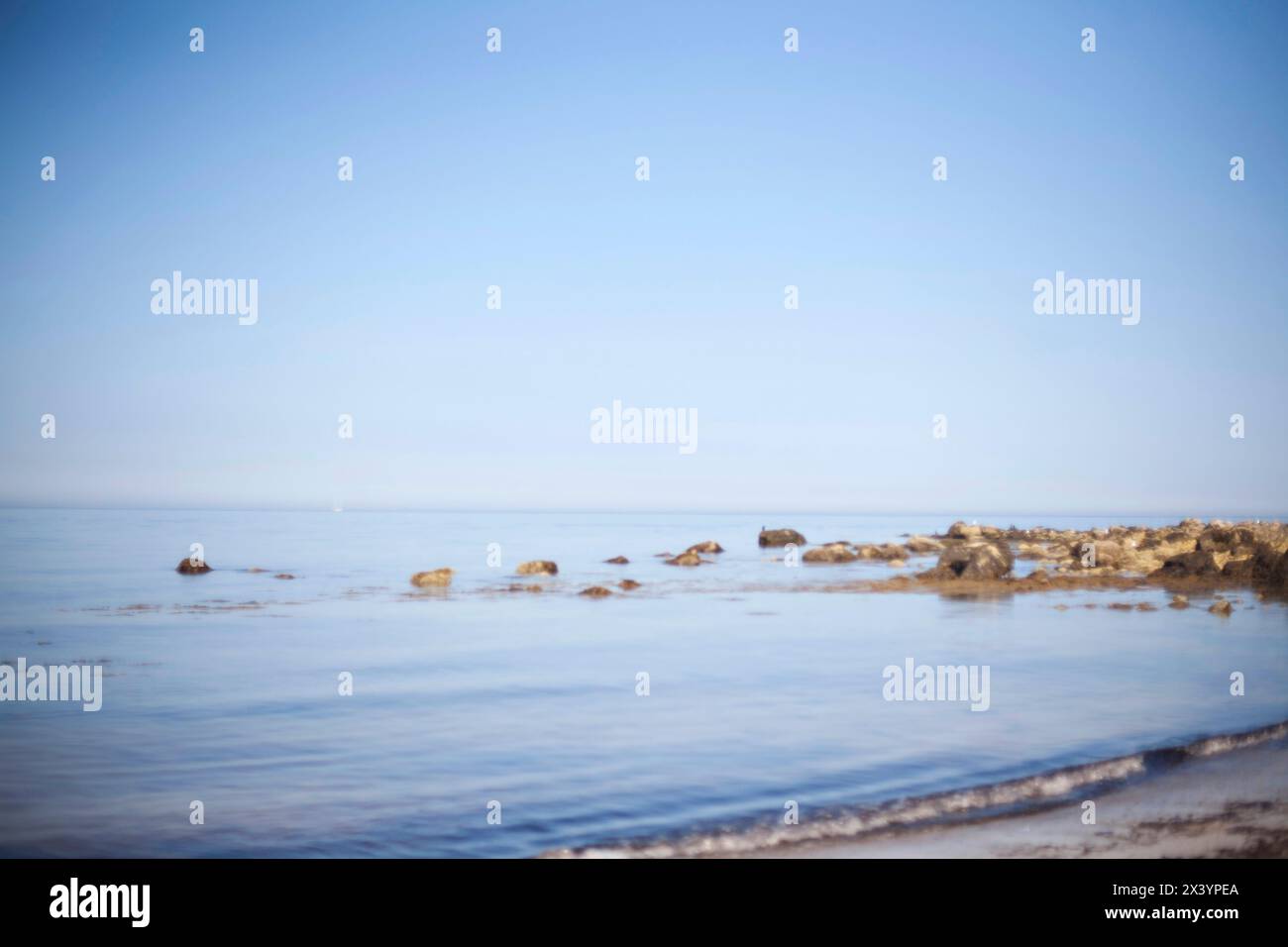 Soft-focus view of a tranquil sea meeting a clear, endless sky Stock ...