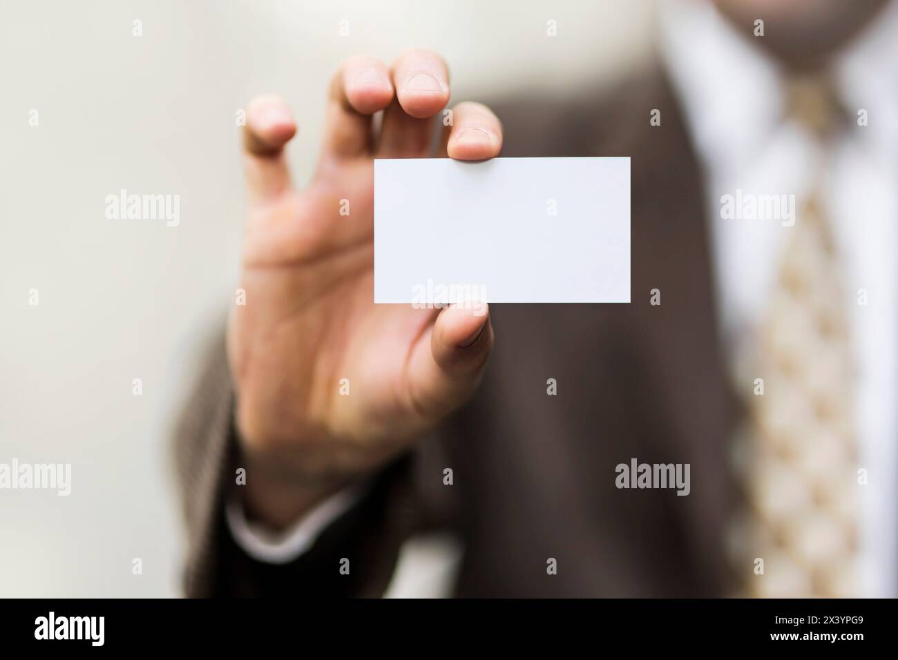 Businessman holding a white card in his hand. You can put a text ...