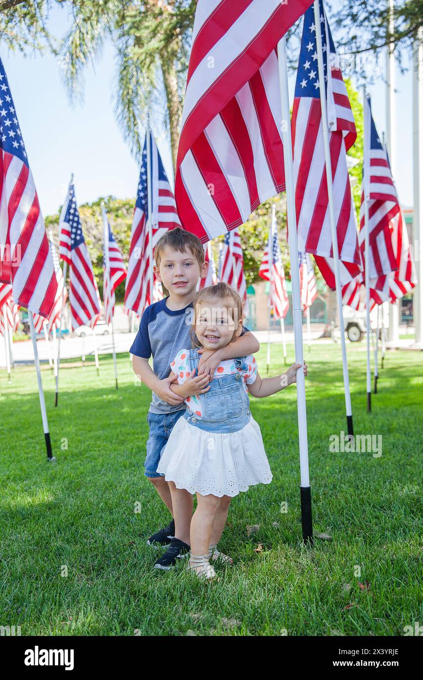 Brother and sister sharing a moment among American flags Stock Photo ...