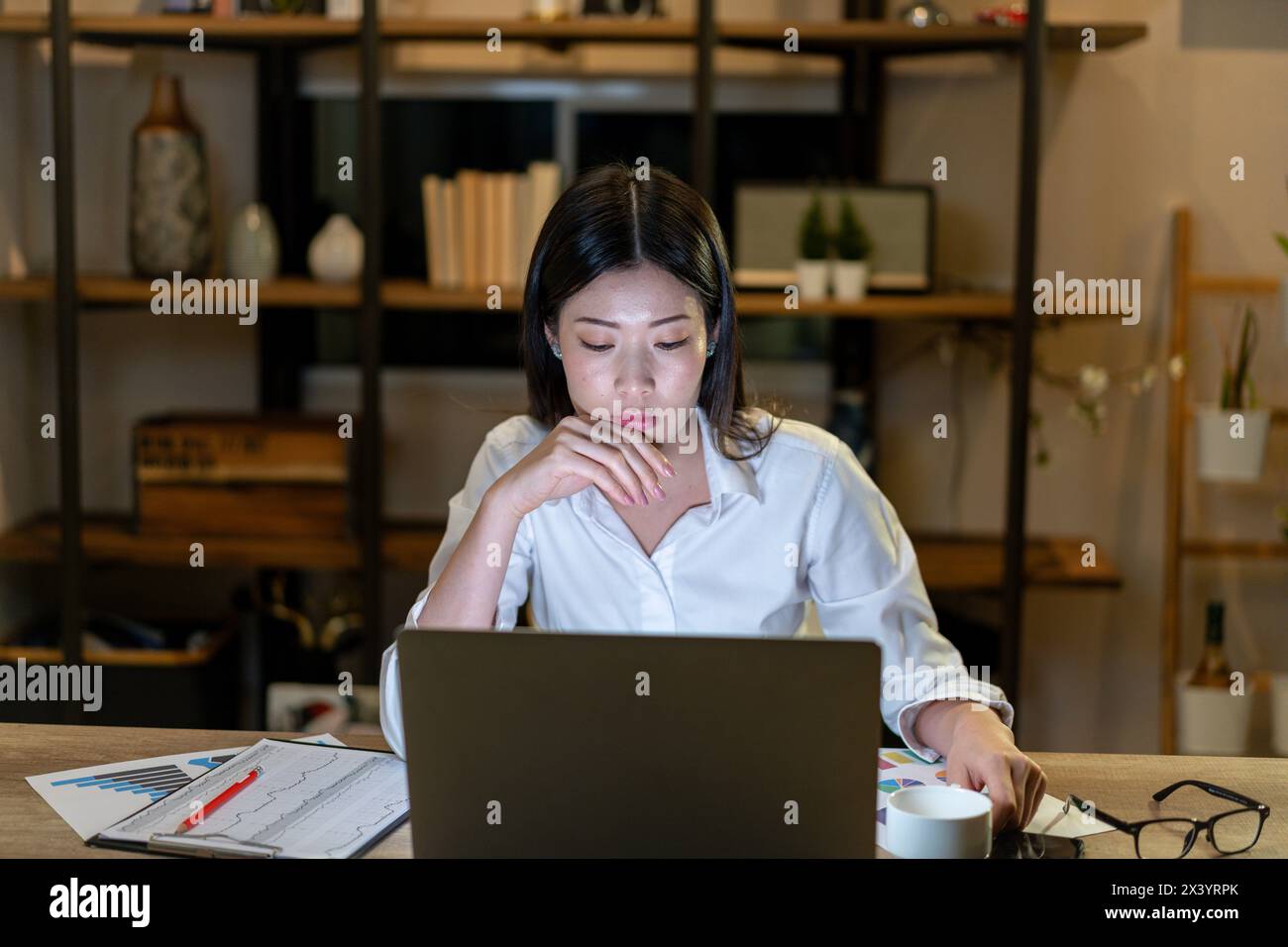 The young woman is working late into the night Stock Photo - Alamy
