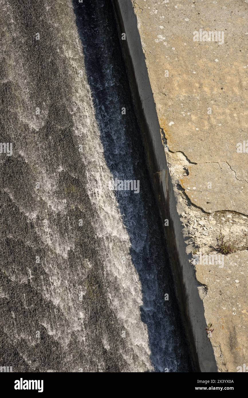 A concrete ramp surface with some damage to evacuate water from a dam ...