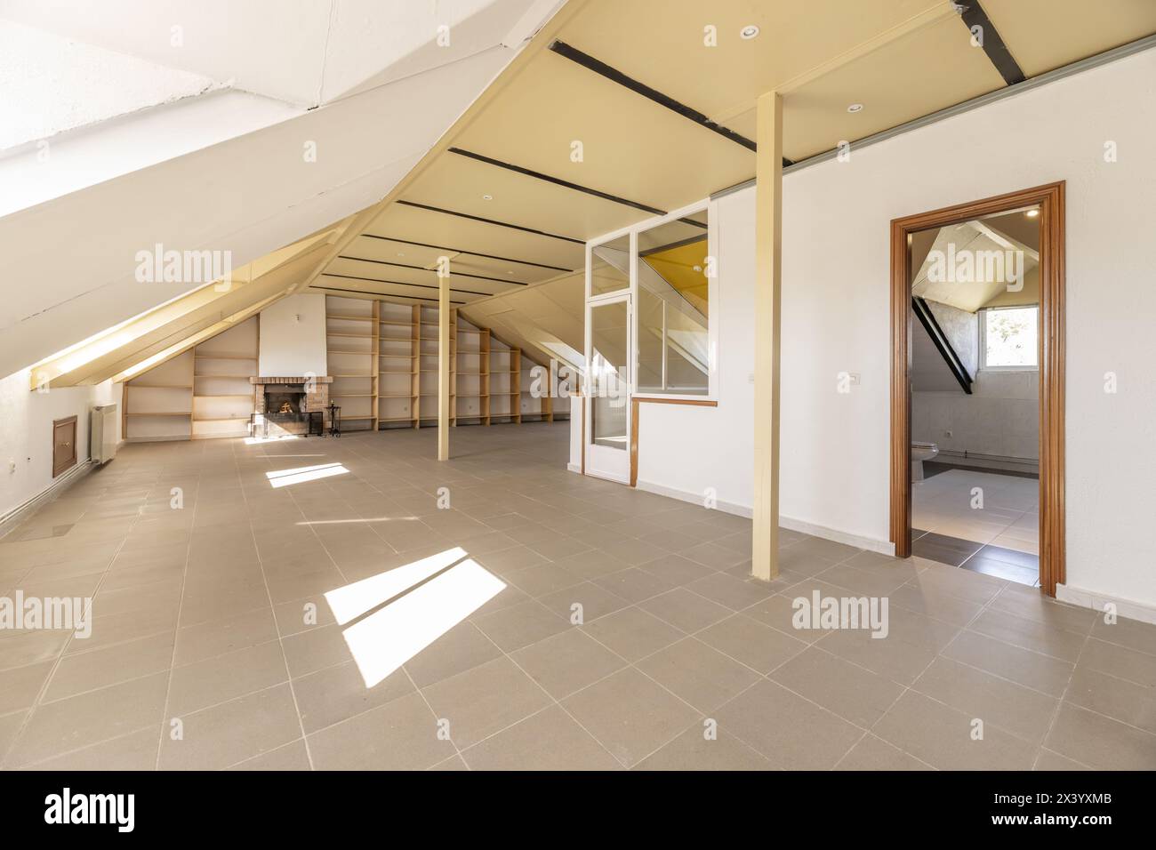 Large attic with a metal column in the center, a wall with shelves and ...