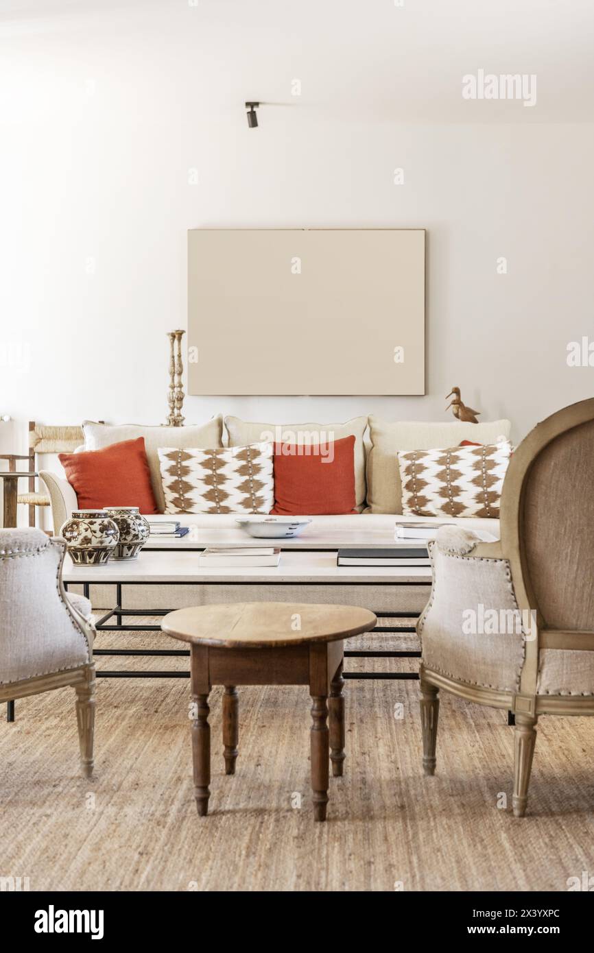Living room with wooden furniture, white marble coffee tables and ...