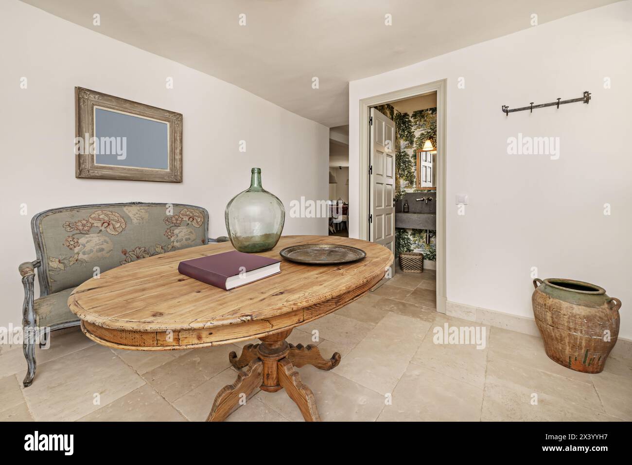 Beautiful main hall of a country house with upholstered bench and ...