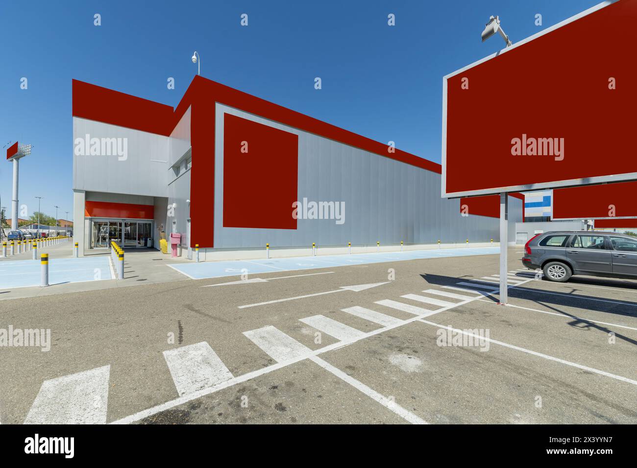 Vehicle parking area outside a shopping center with marked spaces for ...