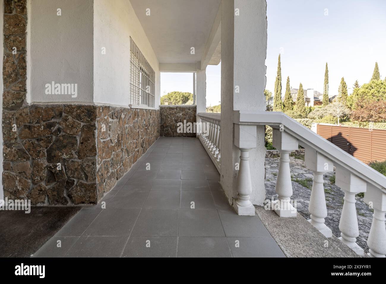 white balustrades of a long terrace outside terrace of a detached house ...