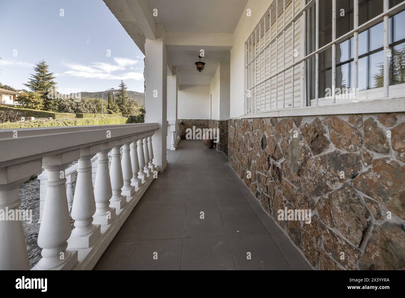 white balustrades of a long terrace outside terrace of a detached house ...