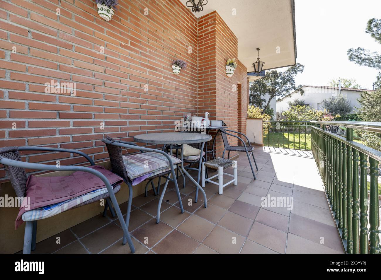 An outdoor terrace of a single-family home with terracotta floors and ...