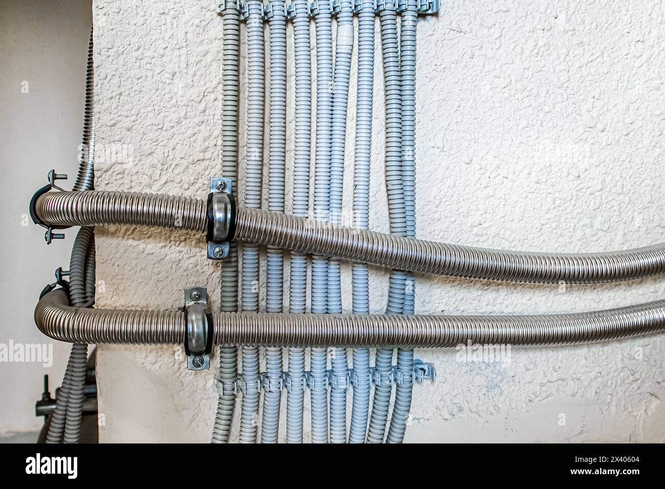 Laying power cables on wall during building construction. Insulated ...