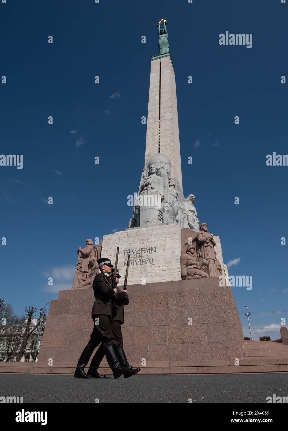 wo soldiers march in front of the Freedom Monument in Riga. The ...
