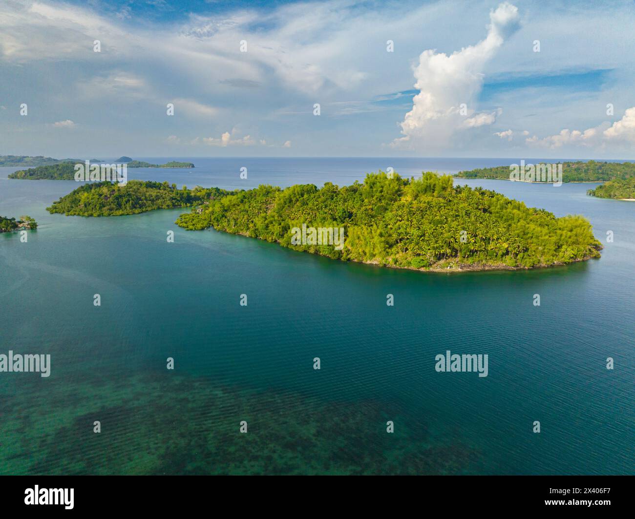 Top survey of cluster of islest under blue sky and clouds. Blue sea and ...