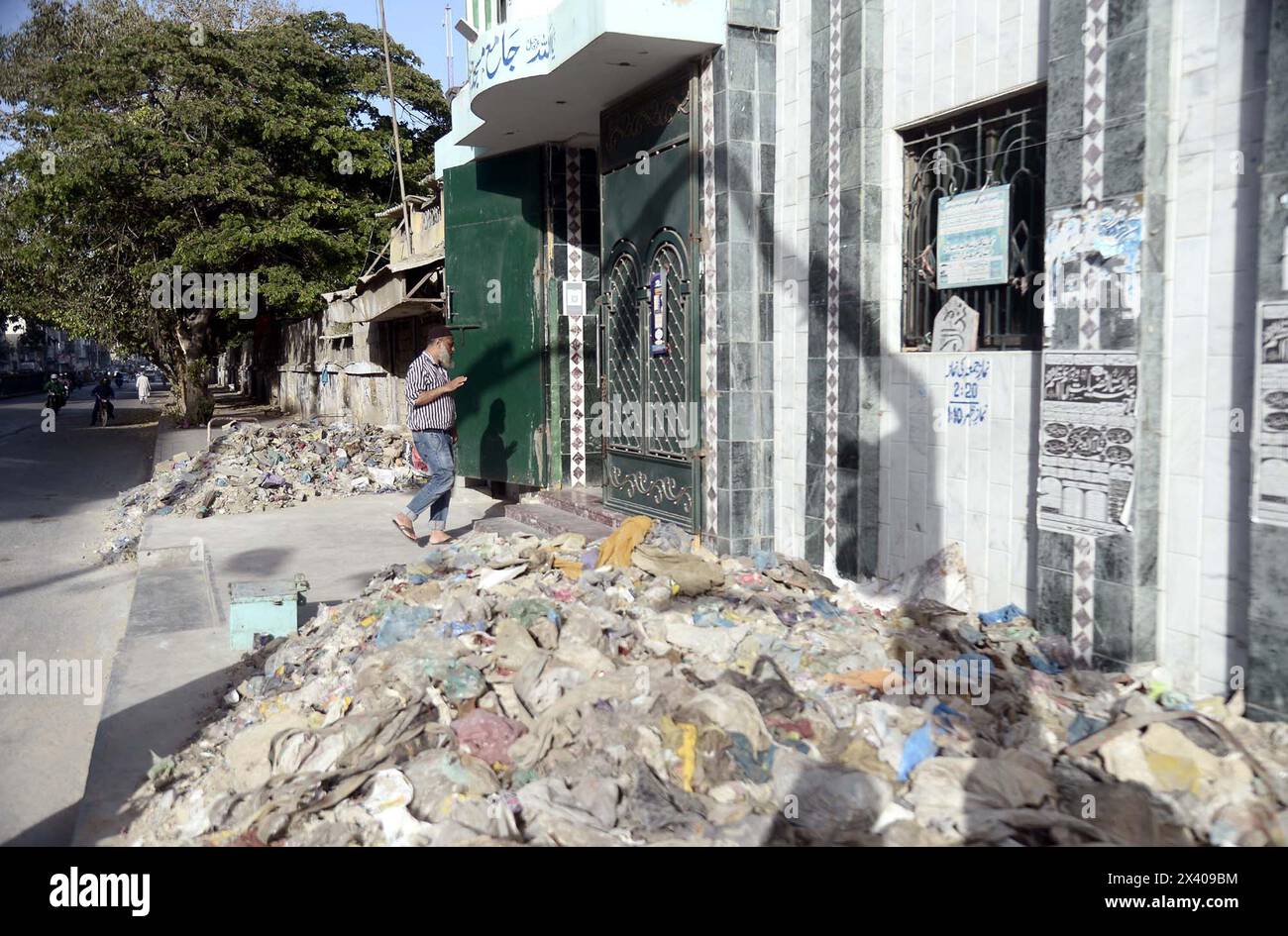 View of huge heap of garbage outside Main Gate of Mosque on a footpath ...