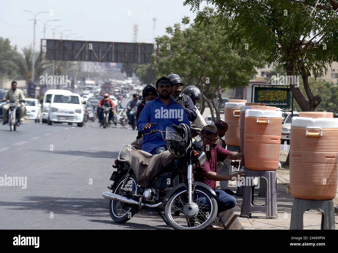 Commuters are drinking chilled water to beat the heat of sun at a camp ...